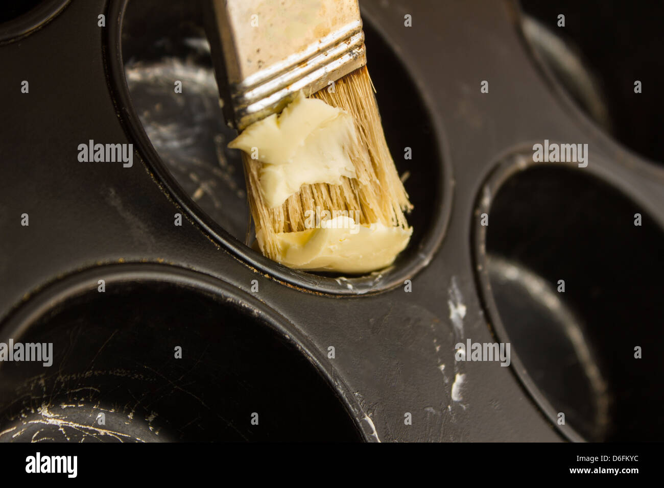 greasing the muffin baking form Stock Photo - Alamy