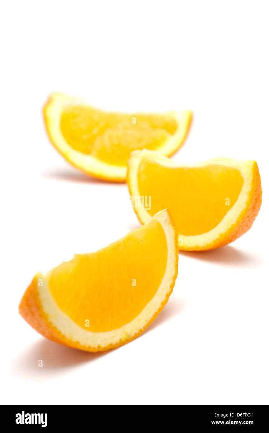 Orange segments on white background Stock Photo - Alamy