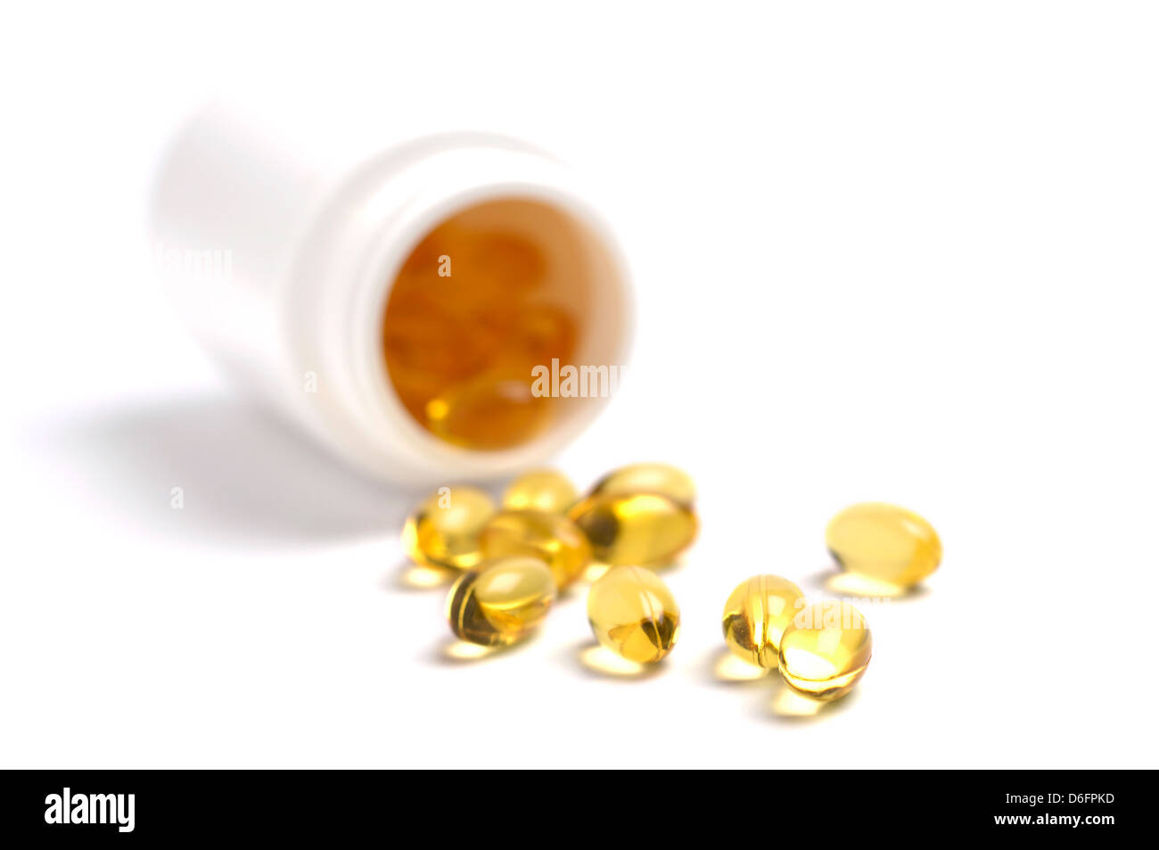 Cod Liver Oil capsules spilling from bottle Stock Photo - Alamy