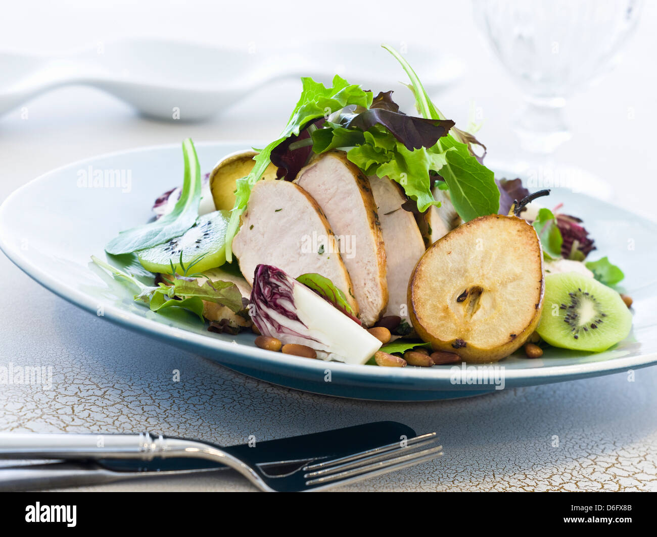 Chicken , roasted pear, kiwi, baby lettuce, toasted pignoli Stock Photo ...