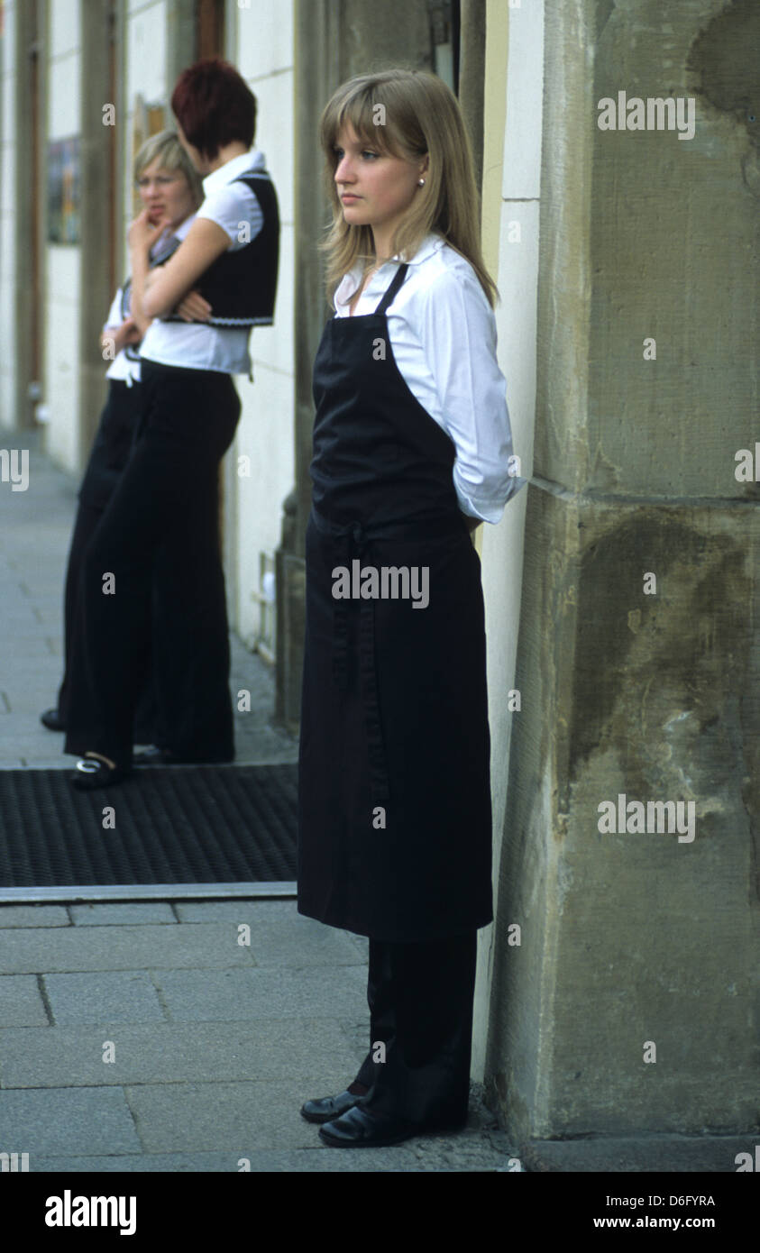 Waitresses waiting for customers at a restaurant door, Main Square ...