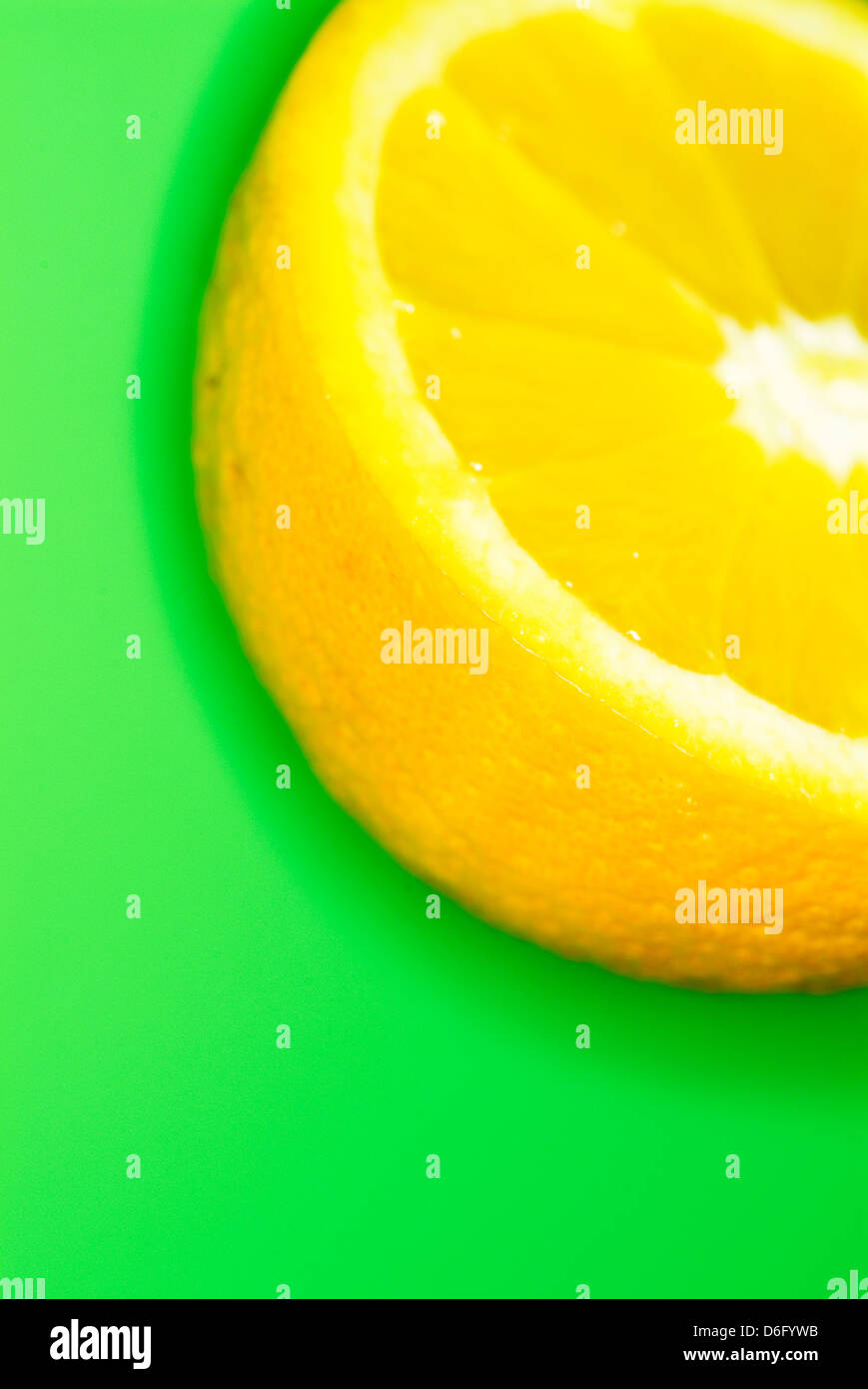 Lemon on green Stock Photo - Alamy