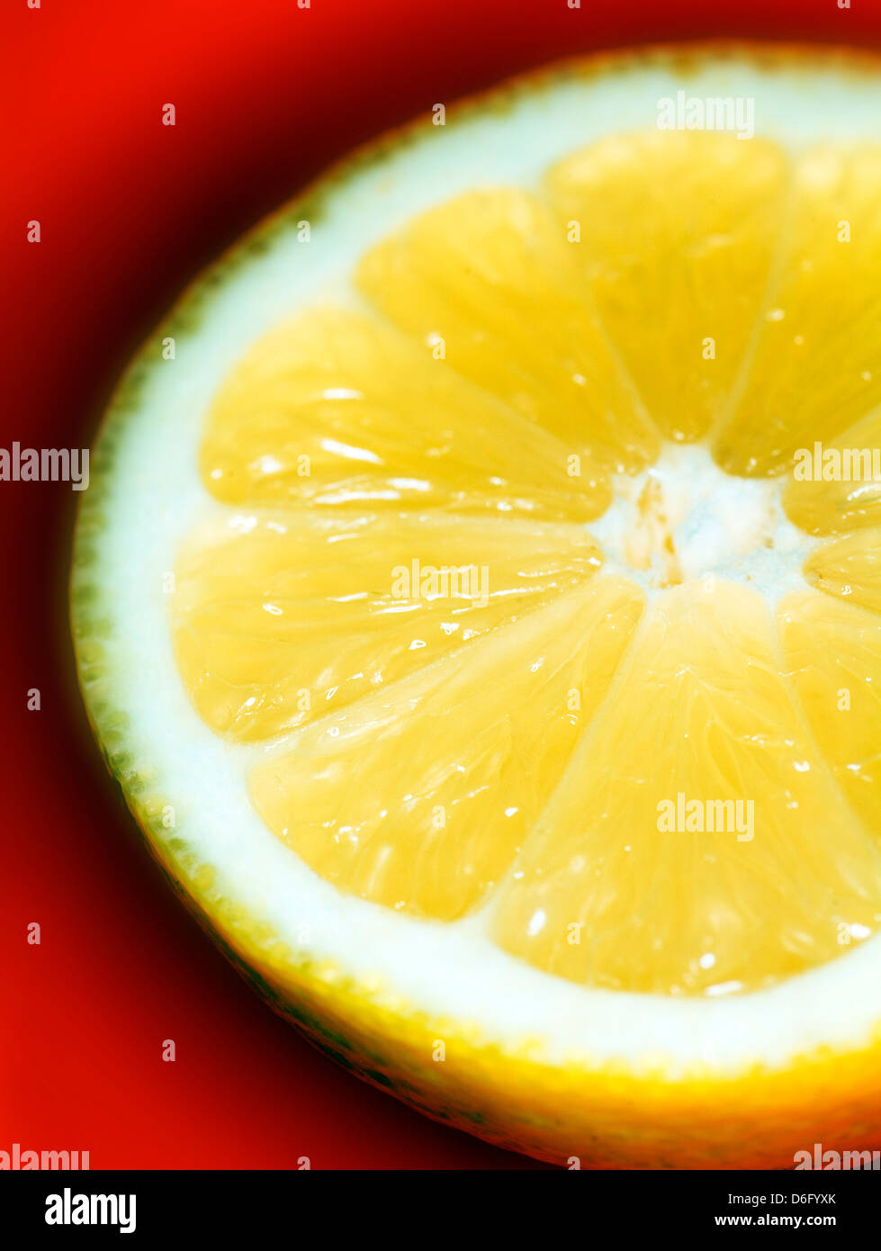 Lemon on red Stock Photo - Alamy