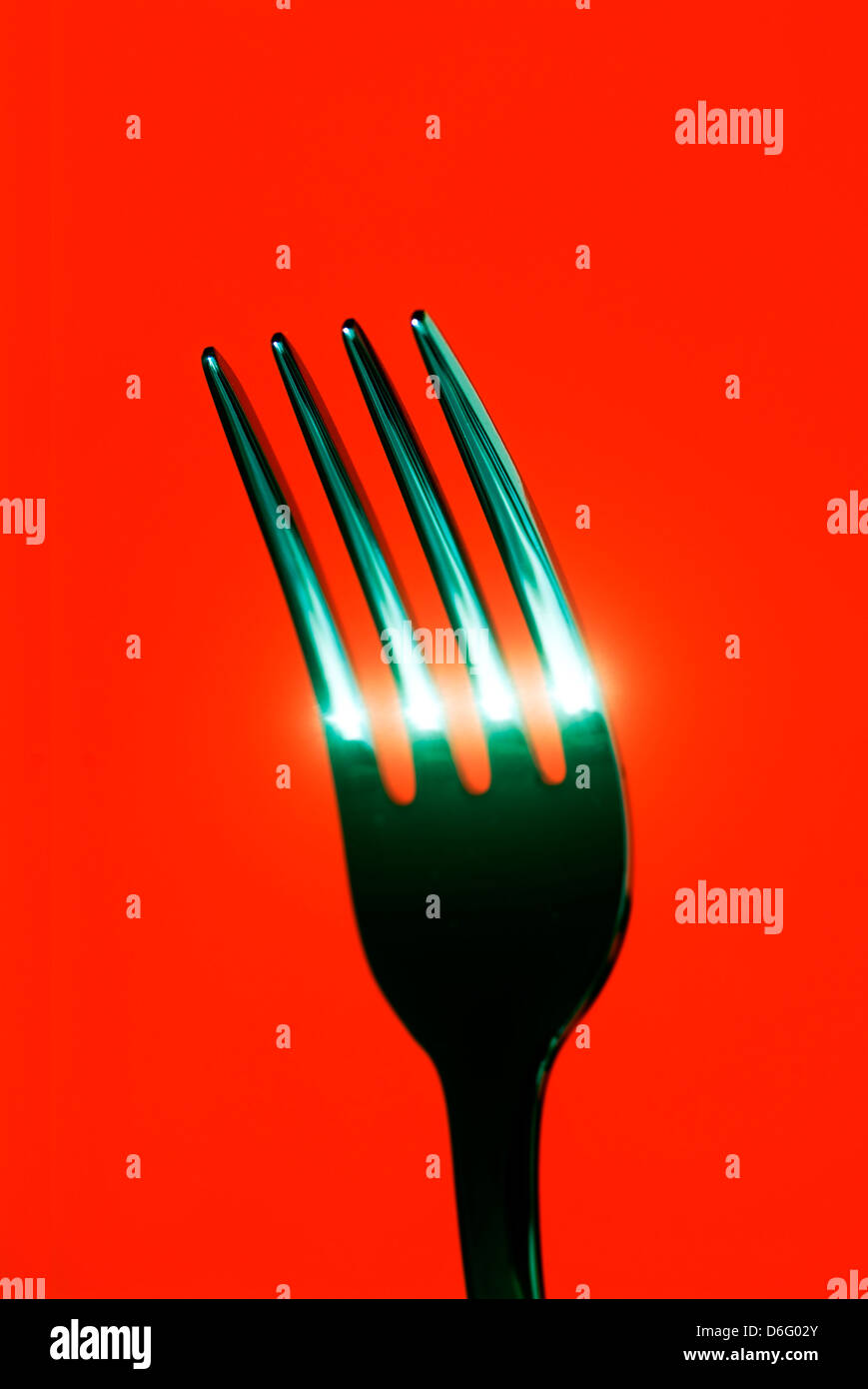 Dinner fork on red Stock Photo - Alamy