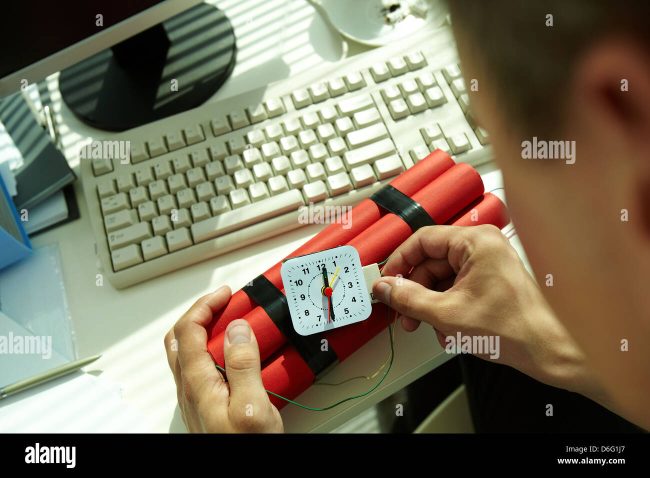 Close-up of businessman preparing bomb in office Stock Photo - Alamy