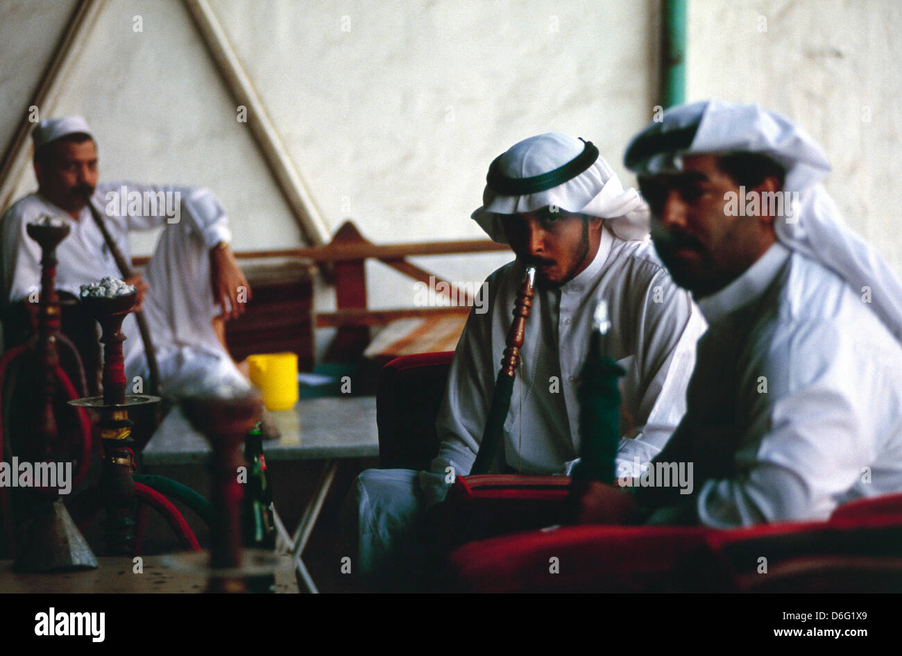 Saudi men relax and smoke "shisha" or waterpipe in downtown al khobar ...