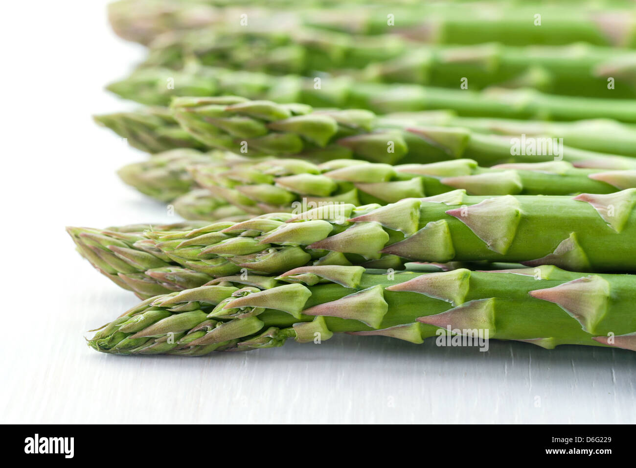 Fresh asparagus closeup on white wooden background Stock Photo - Alamy