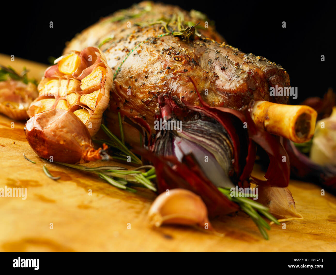 Sliced leg of stuffed lamb with garlic, rosemary and roast onion Stock ...
