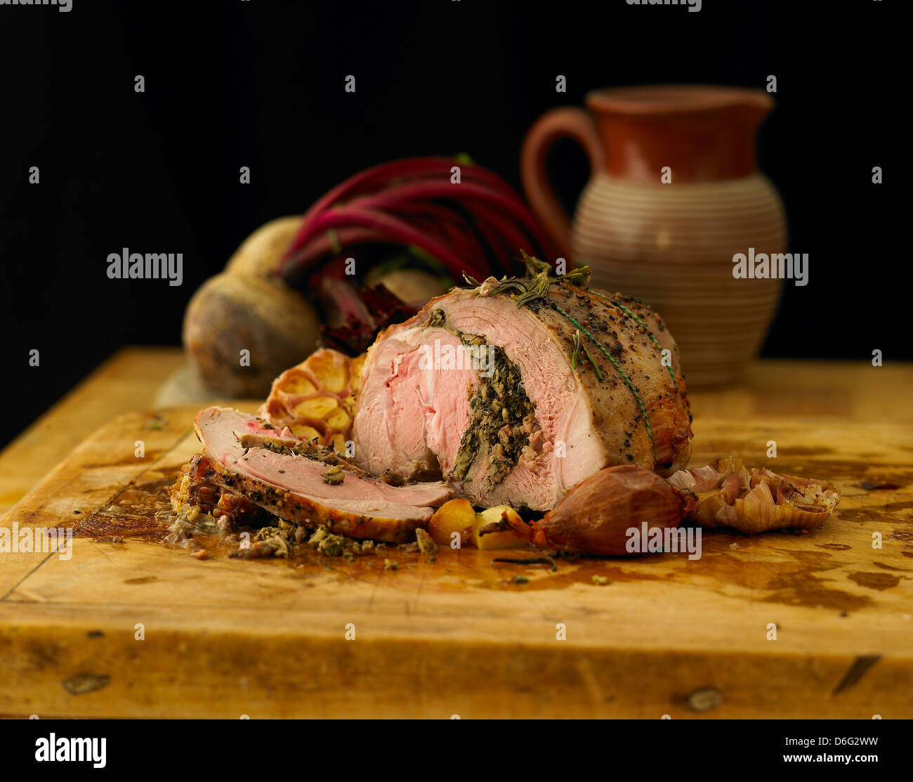Sliced leg of stuffed lamb with garlic, rosemary and roast onion Stock ...