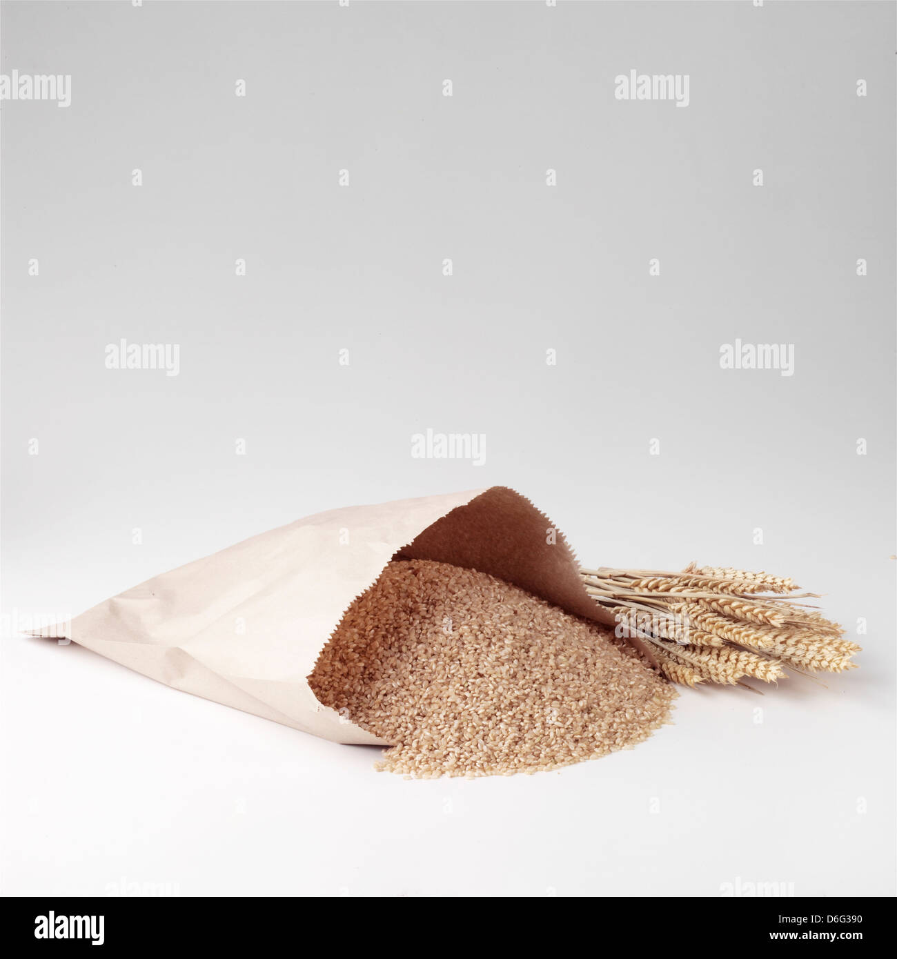 Wheat stalks and a bag of brown rice Stock Photo - Alamy
