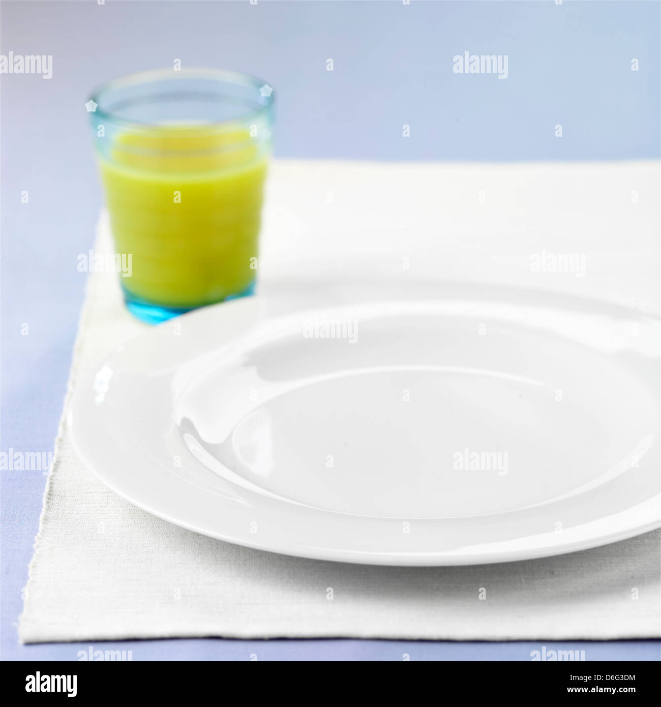 Empty plate and a glass of orange juice Stock Photo - Alamy