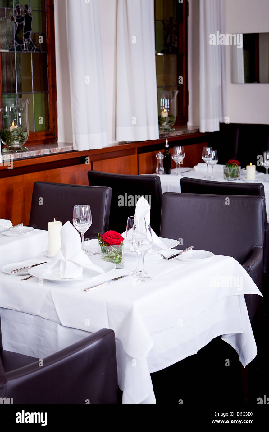 tables in restaurant with white tablecloth and elegant dish and ...