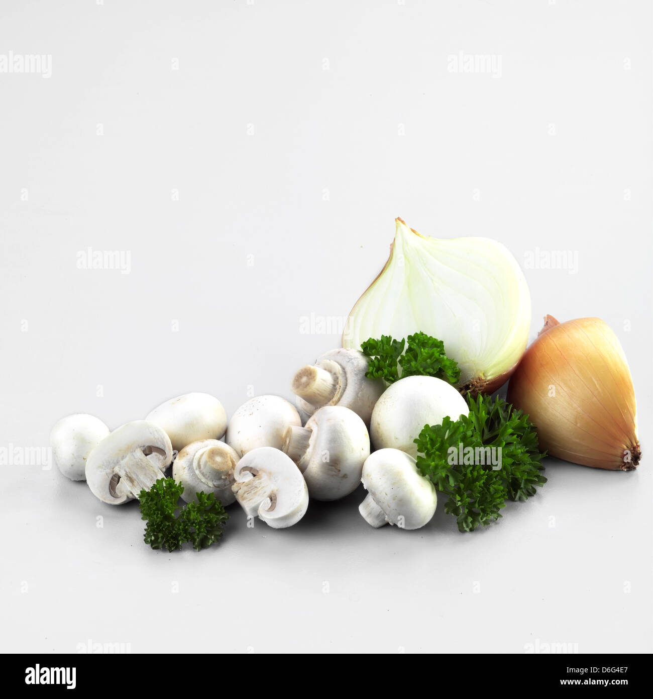Button mushrooms, parsley and halved onion cut out Stock Photo - Alamy