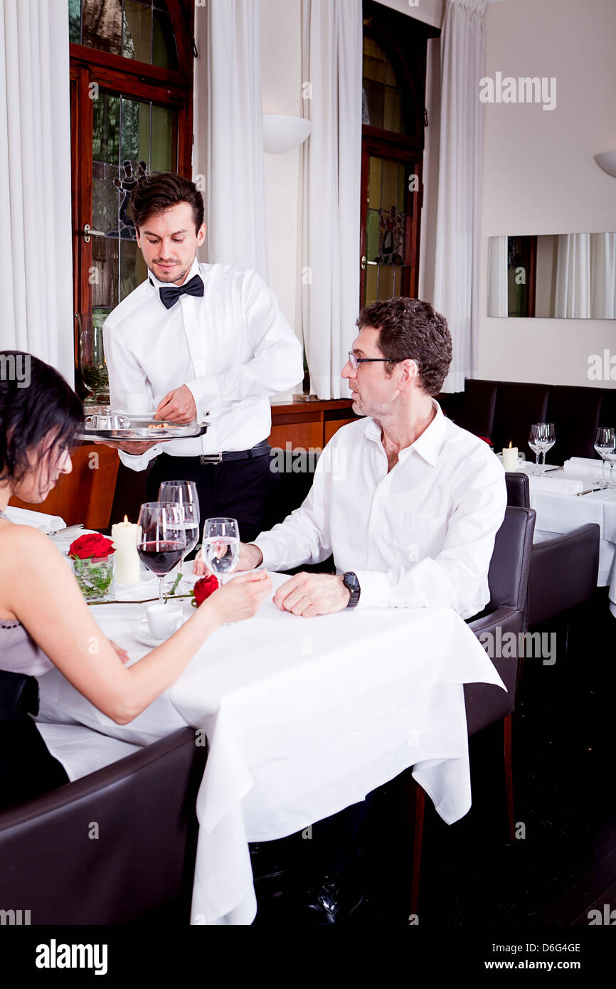 waiter serve fresh espresso for happy couple in restaurant Stock Photo ...