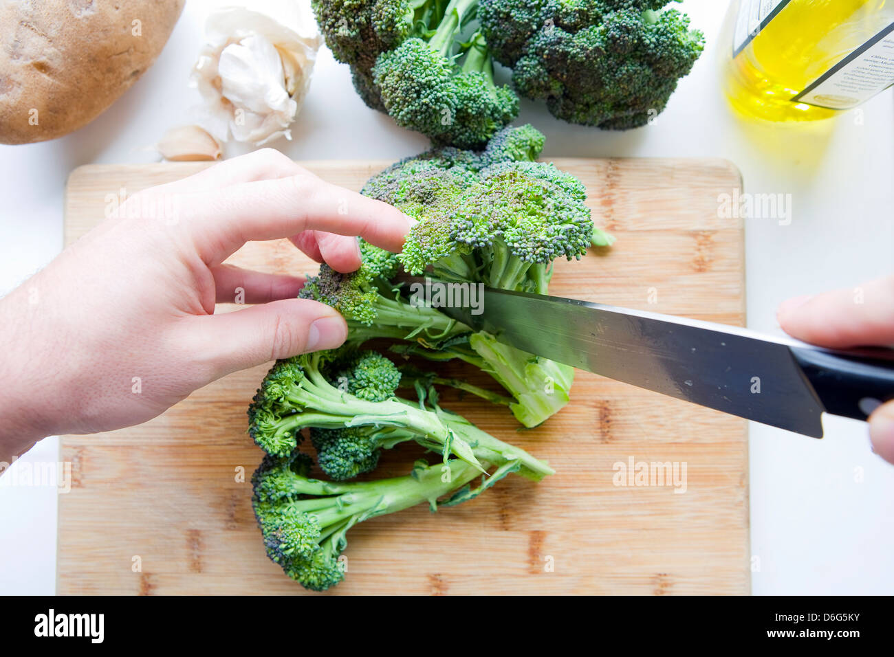 Chopping broccoli into florets for a soup - with recipe Stock Photo - Alamy