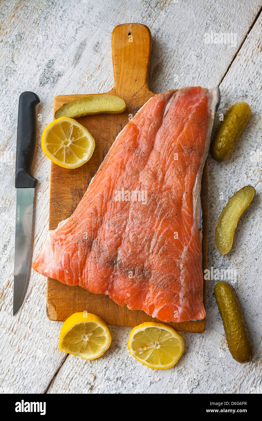 Salmon raw fish on chopping board on white wooden background Stock ...