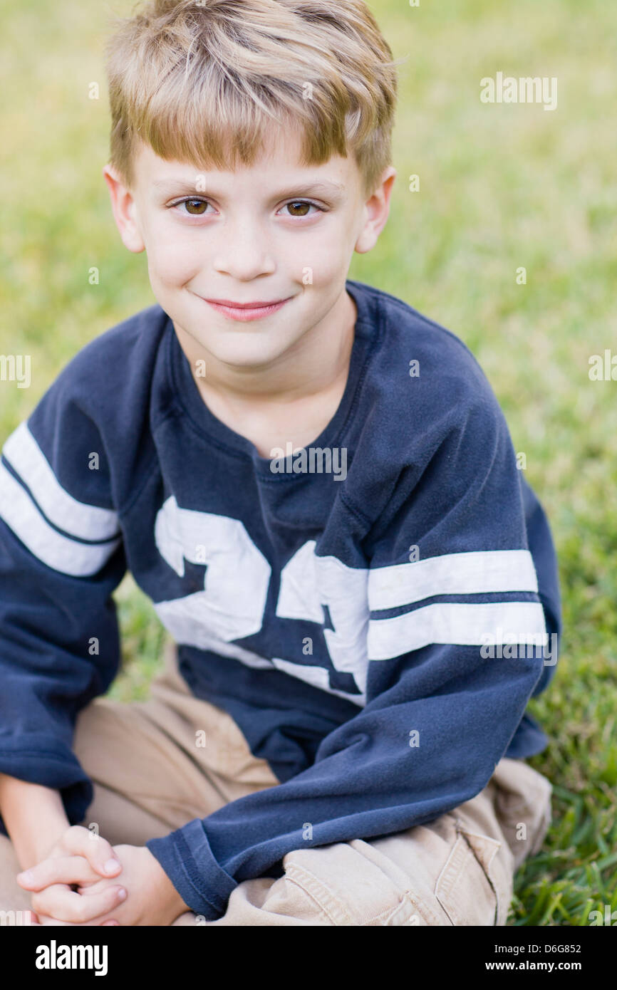 Caucasian boy smiling on lawn Stock Photo - Alamy
