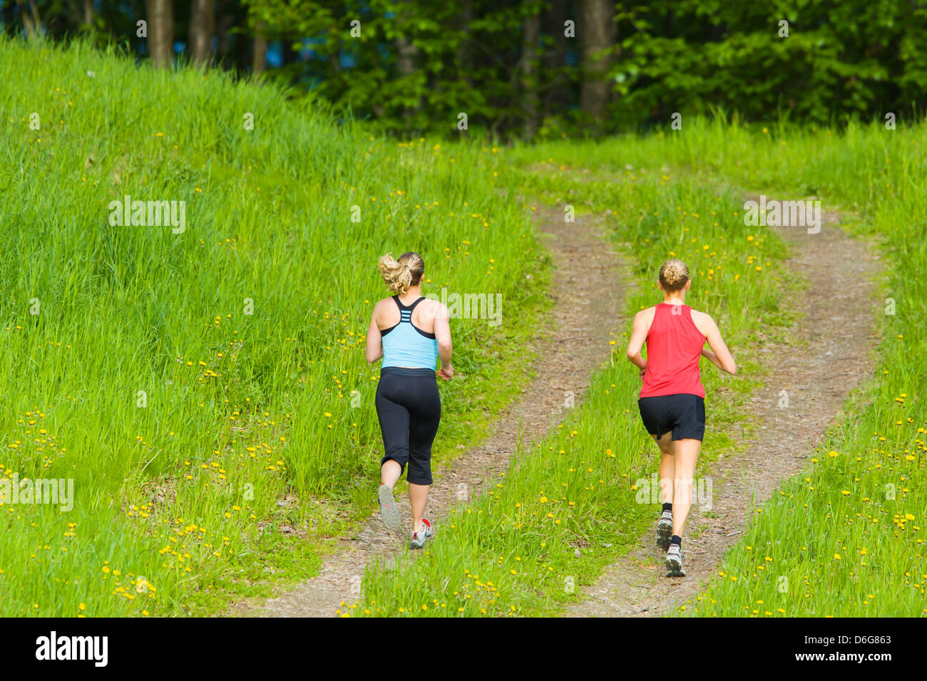 Caucasian women running on path Stock Photo - Alamy