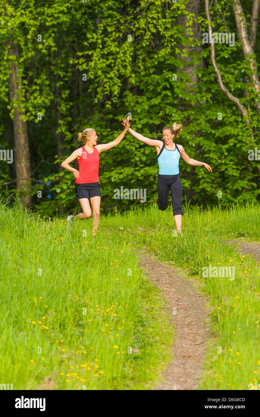 Women laughing high fiving hi-res stock photography and images - Alamy