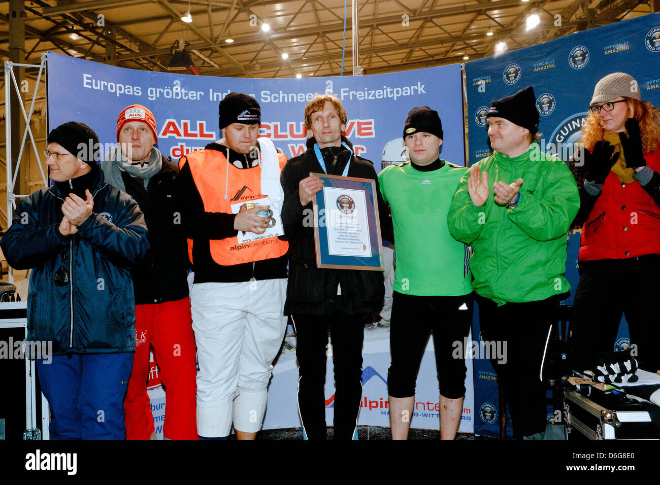 Kai Martin (C) shows his certificate after finishing his 5,000 meters ...