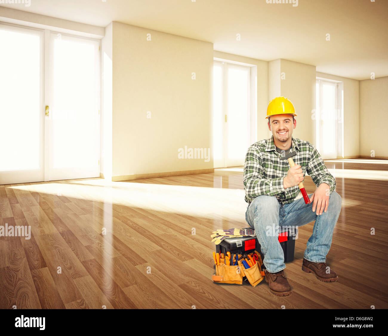 smiling worker sit in empty house Stock Photo - Alamy