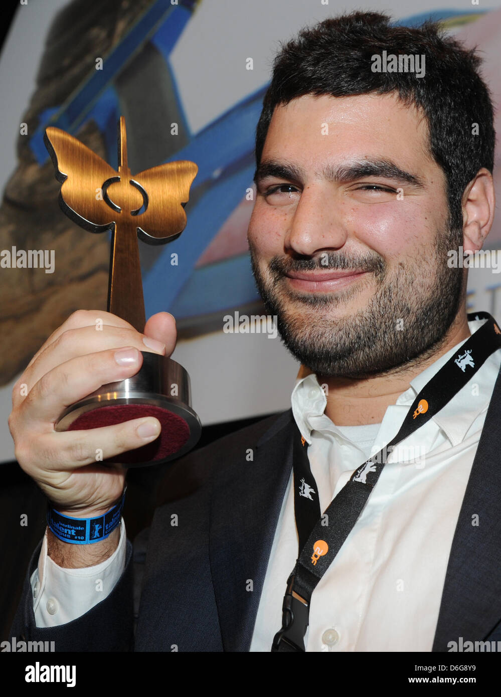Israeli director Rafael Balulu shows his Berlin Today Award he received ...