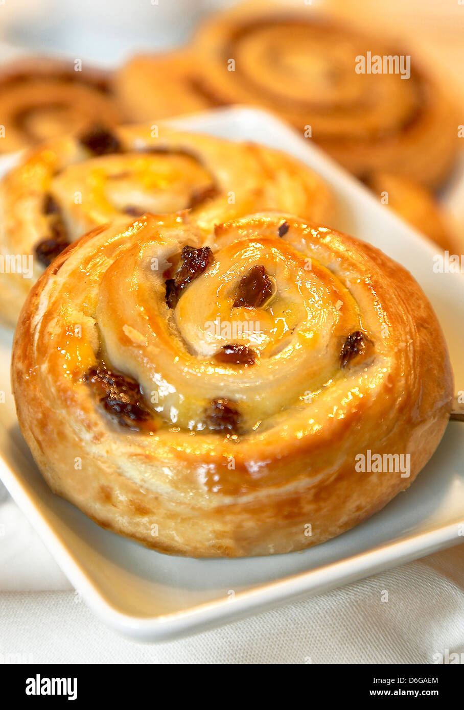 Pain aux raisin on white plate Stock Photo - Alamy