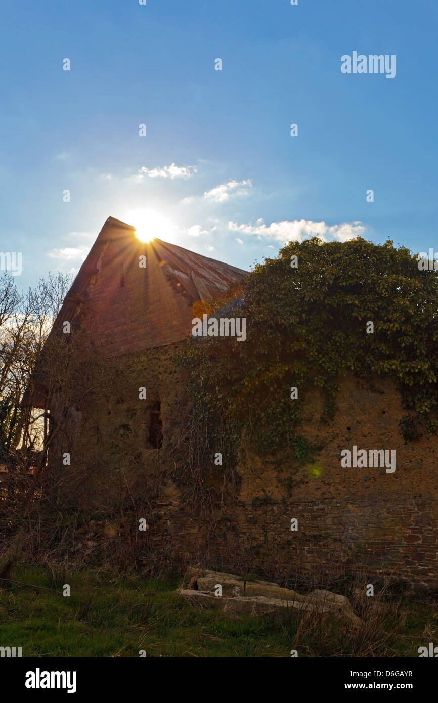 An old Devon cobb barn backlit by the sun (This technique is called ...