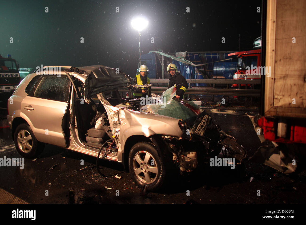 Firefighters look at a car wreck on the autobahn A 57 near Dormagen ...
