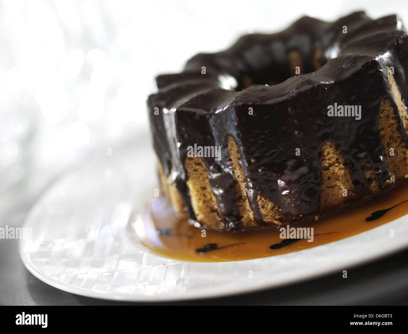 Chocolate covered sponge pudding Stock Photo - Alamy