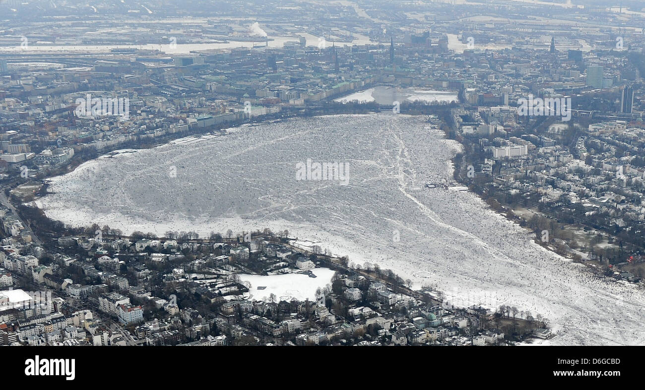 Thousands of people walk on the frozen Outer Alster in Hamburg, Germany ...