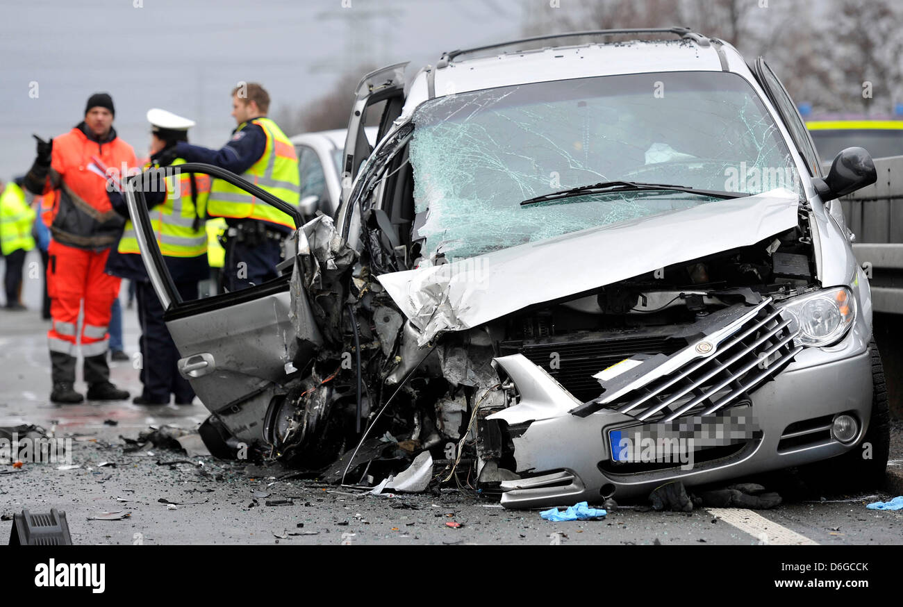 Police officers stand amongst wrecked vehichles on Autobahn 57 near ...