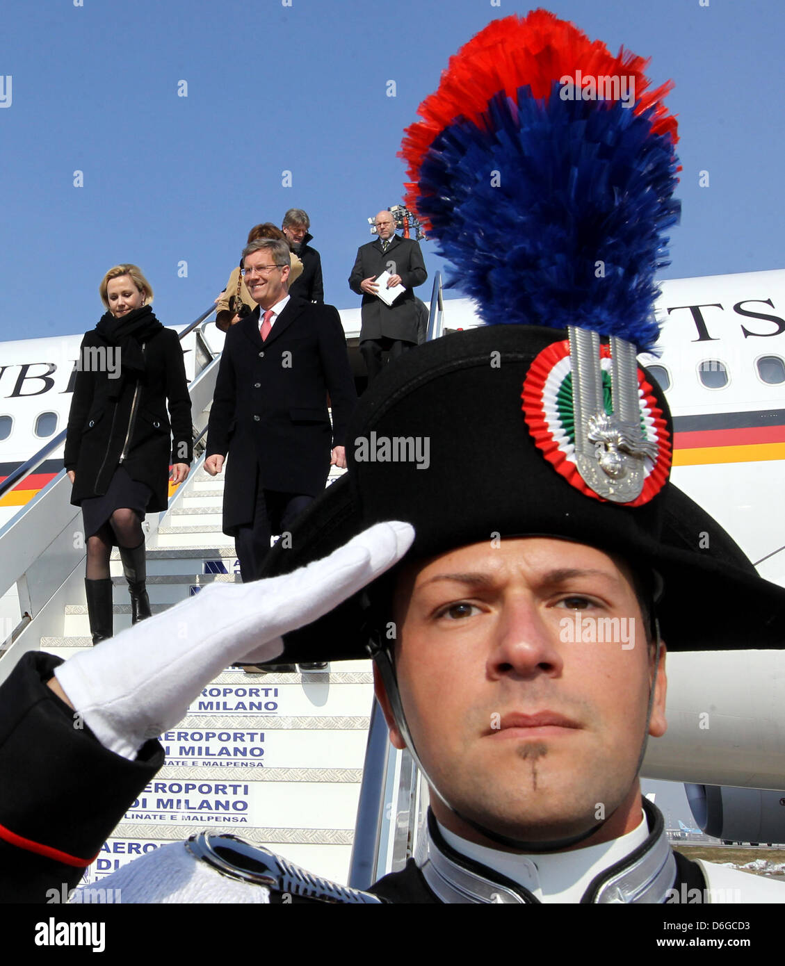 German President Christian Wulff and his wife Bettina (L) walk next to ...