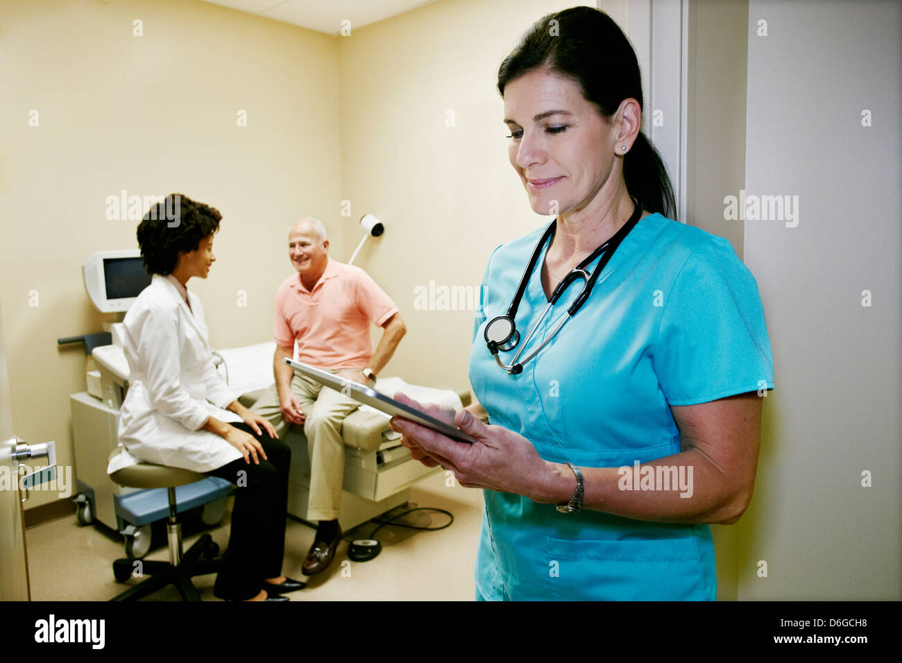 Caucasian nurse using digital tablet Stock Photo - Alamy