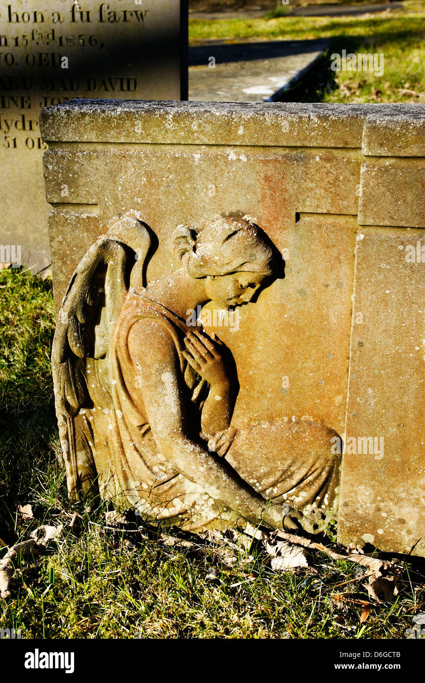 A carving of an Angel on a Grave Stone Stock Photo - Alamy