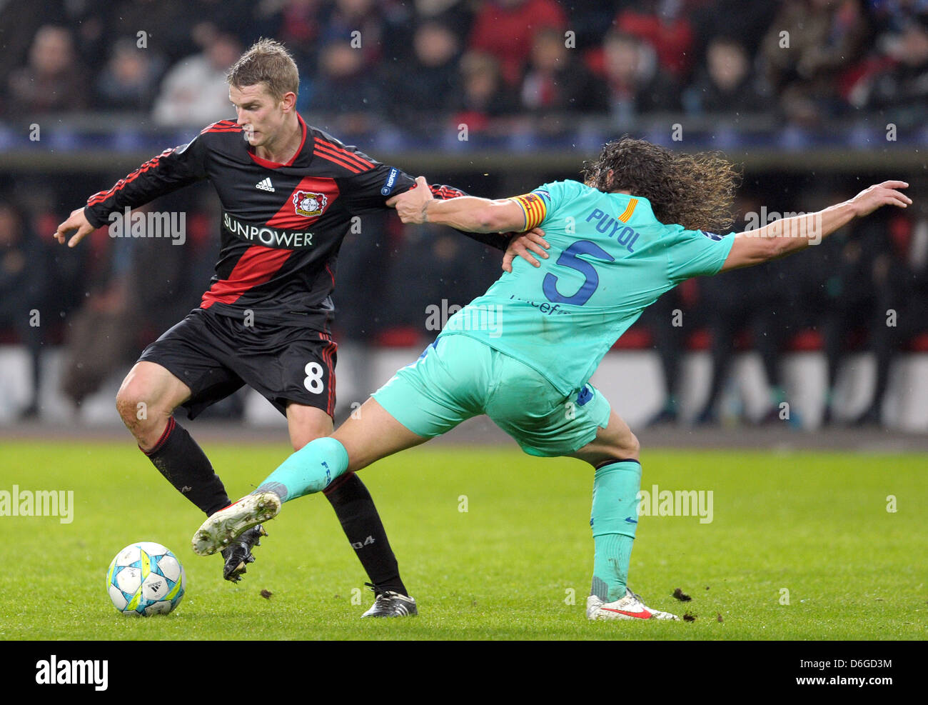 Barcelona's Carles Puyol (R) and Lars Bender of Leverkusen vie for the ...