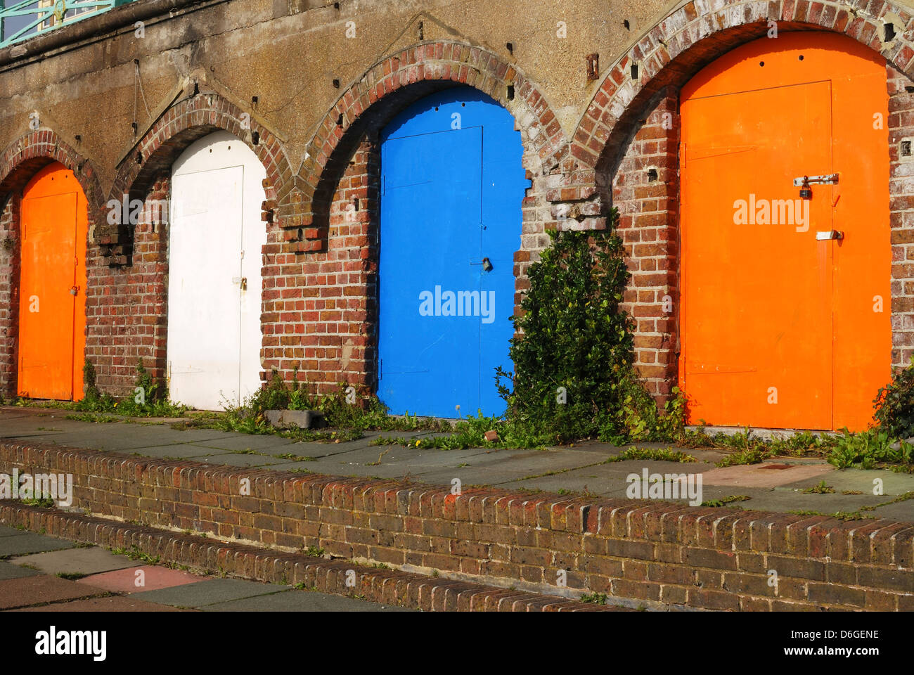 Colorful painted doors to beach huts built under promenade on Brighton ...