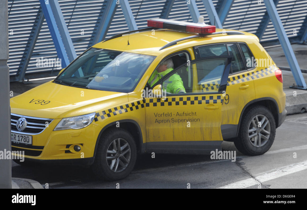 A staff member of the Apron Control sits in his car at the apron of the ...