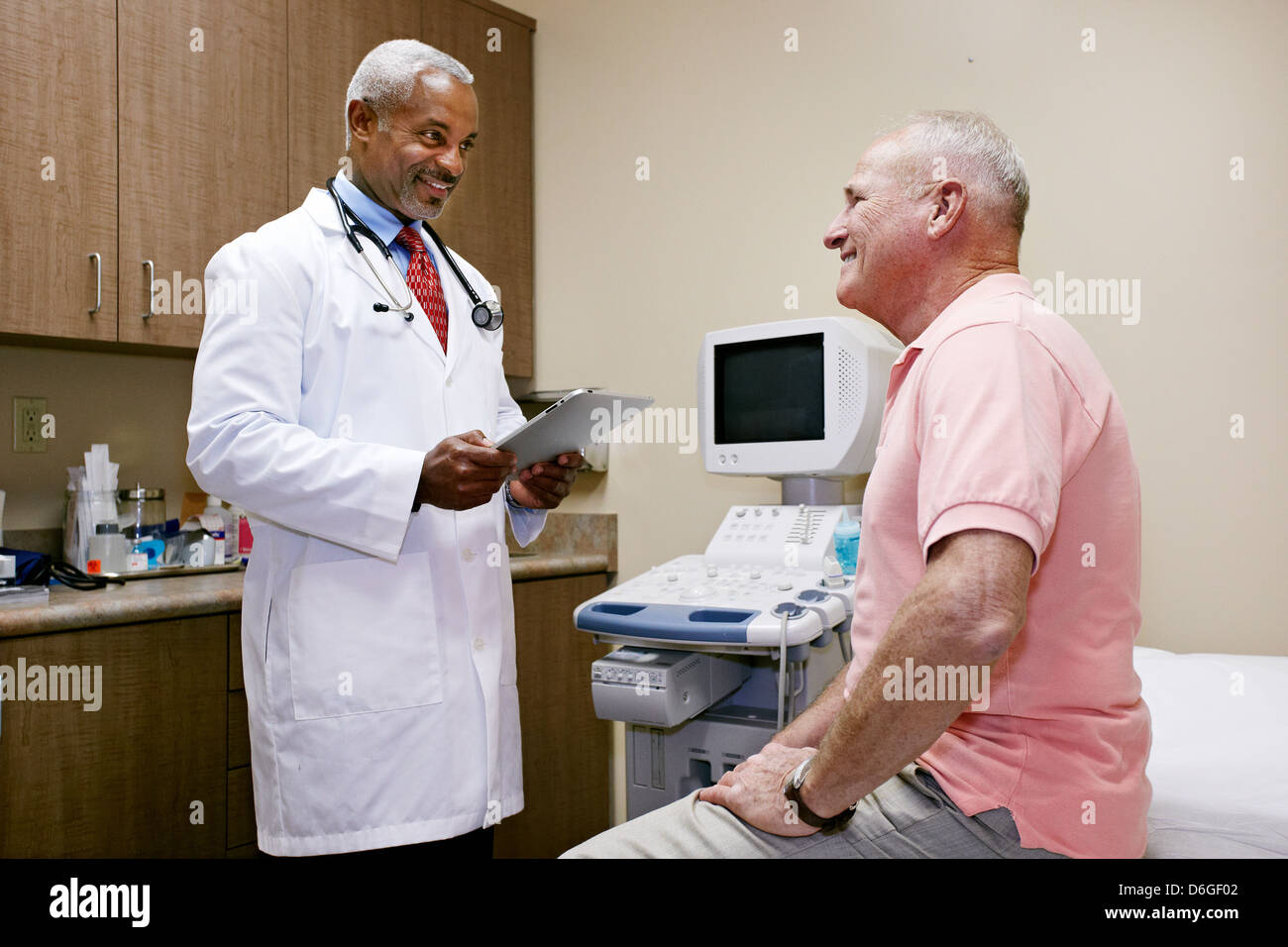 Doctor talking to patient in office Stock Photo - Alamy