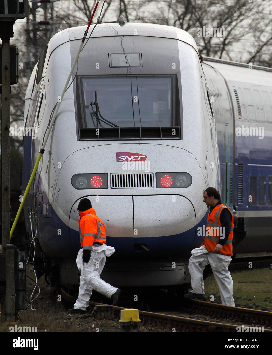 Technicians inspect a double-decker high-speed train from France at the ...