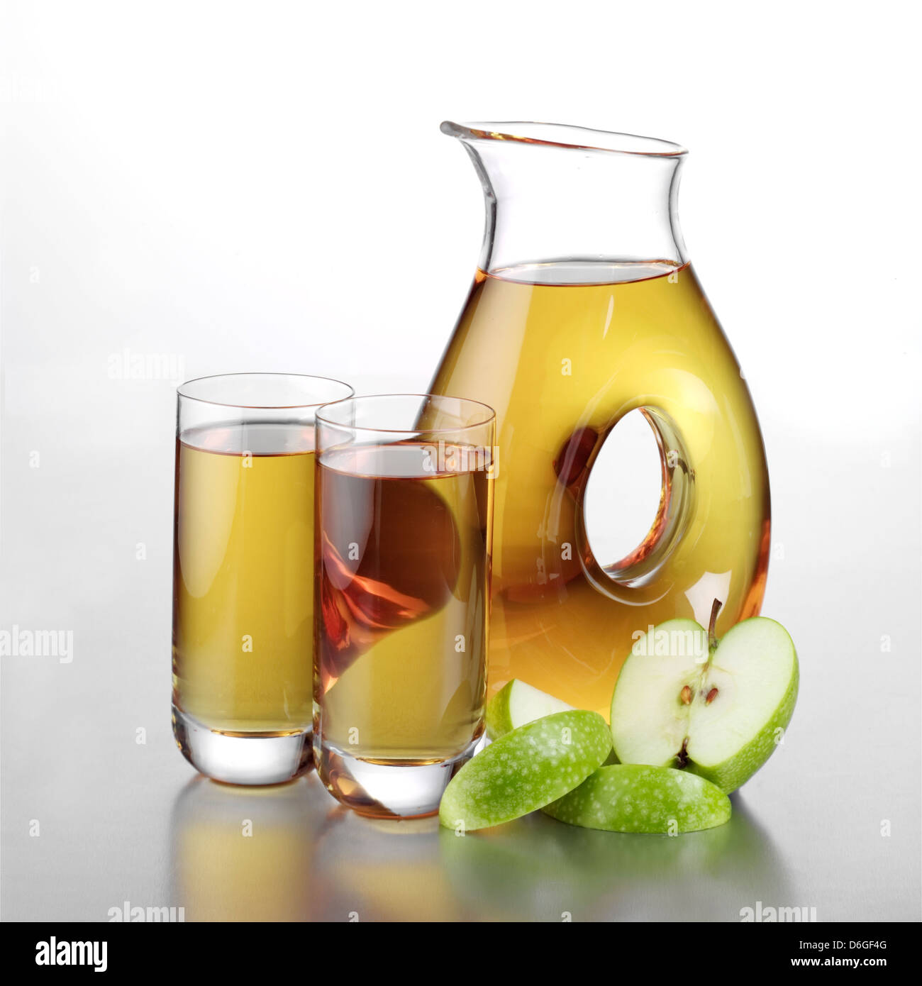 Jug of Apple Juice, Two Full Glasses and Sliced Apple Stock Photo - Alamy