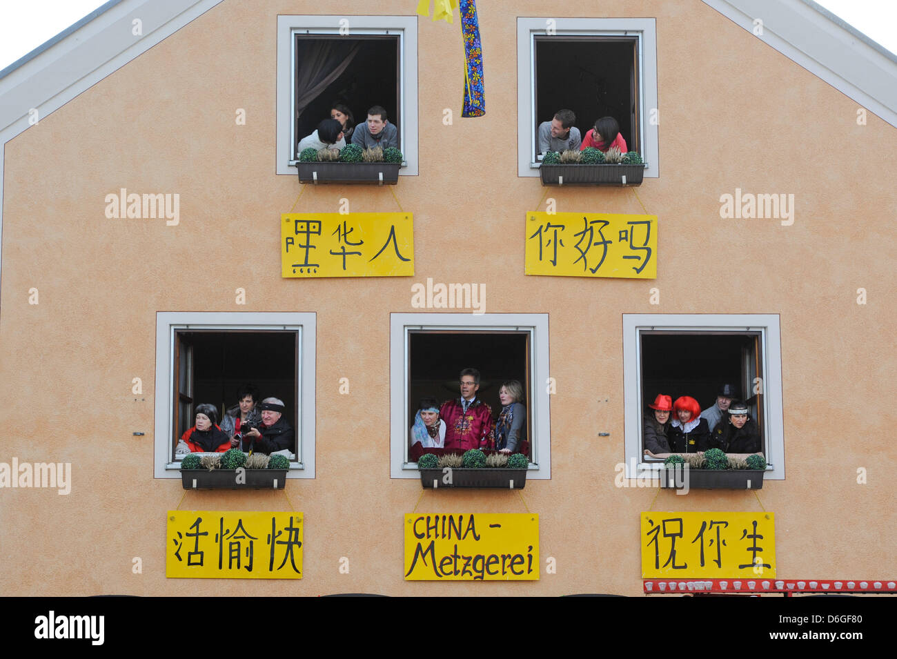 Spectators wave from the windows of a building during the tradition ...