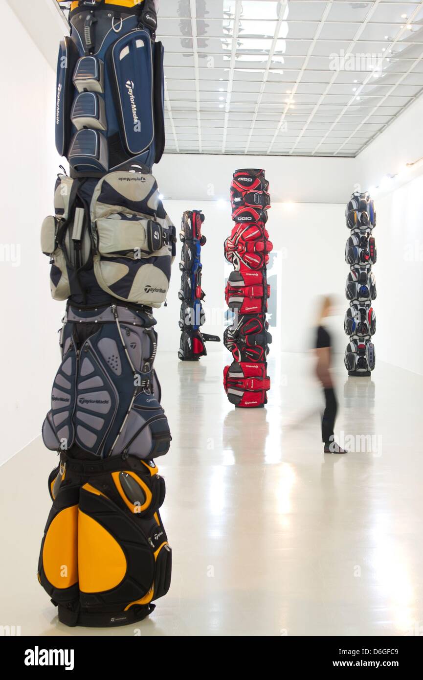 Hannover, Germany. 18 April 2013. A woman walks past Totem poles from ...