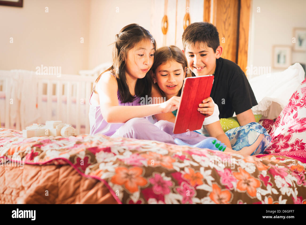Children using digital tablet together Stock Photo - Alamy