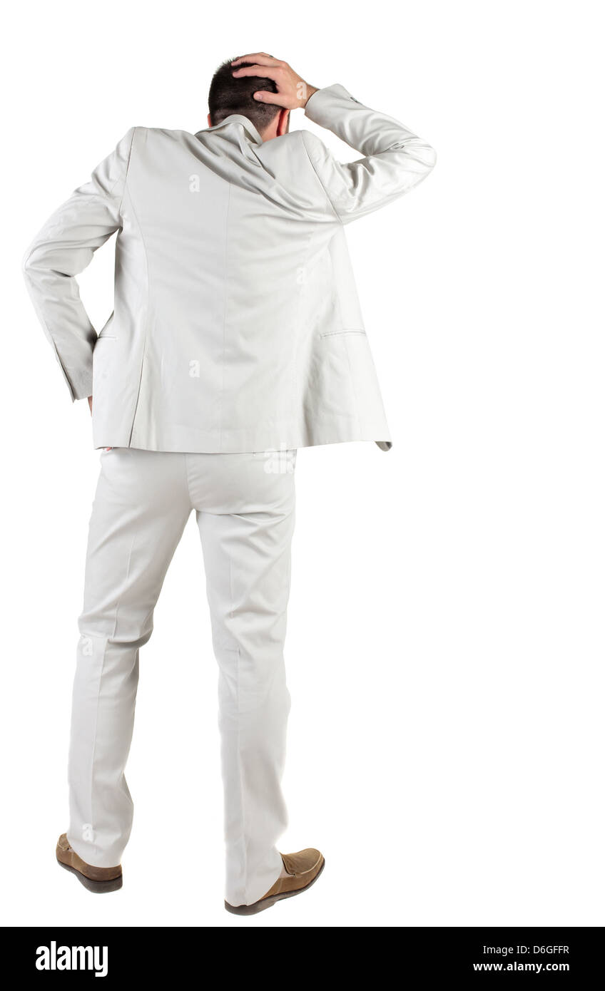 Back view of shocked and scared young business man. Holds hands upwards ...