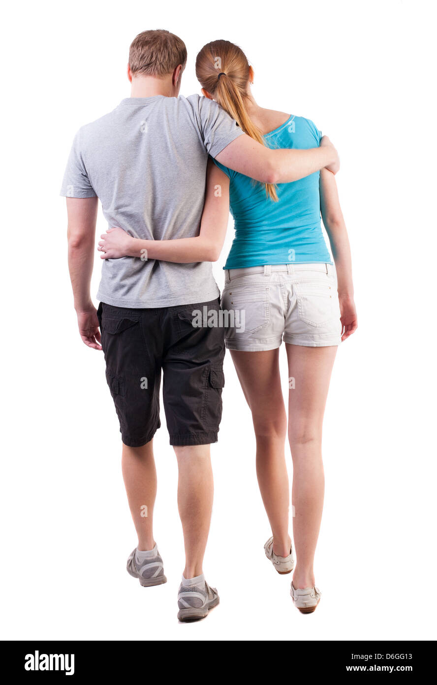 Back view of going young couple (man and woman). walking beautiful ...