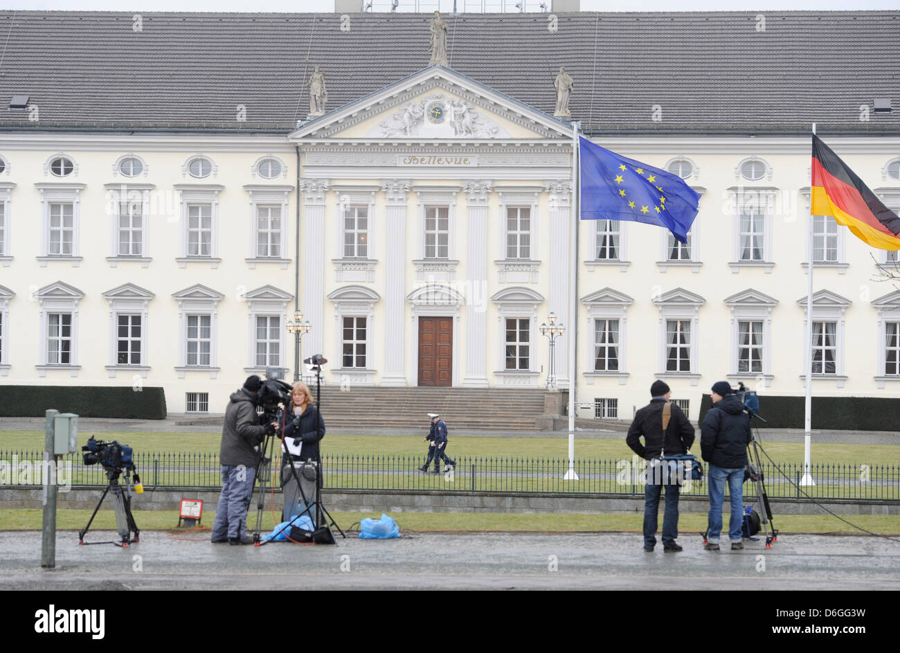 The European flag waves next to journalists working in front of ...