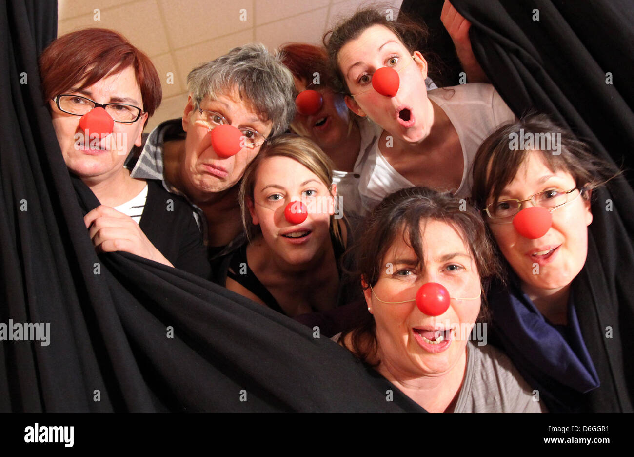 Participants of beginner's course with red noses learn clown techniques ...
