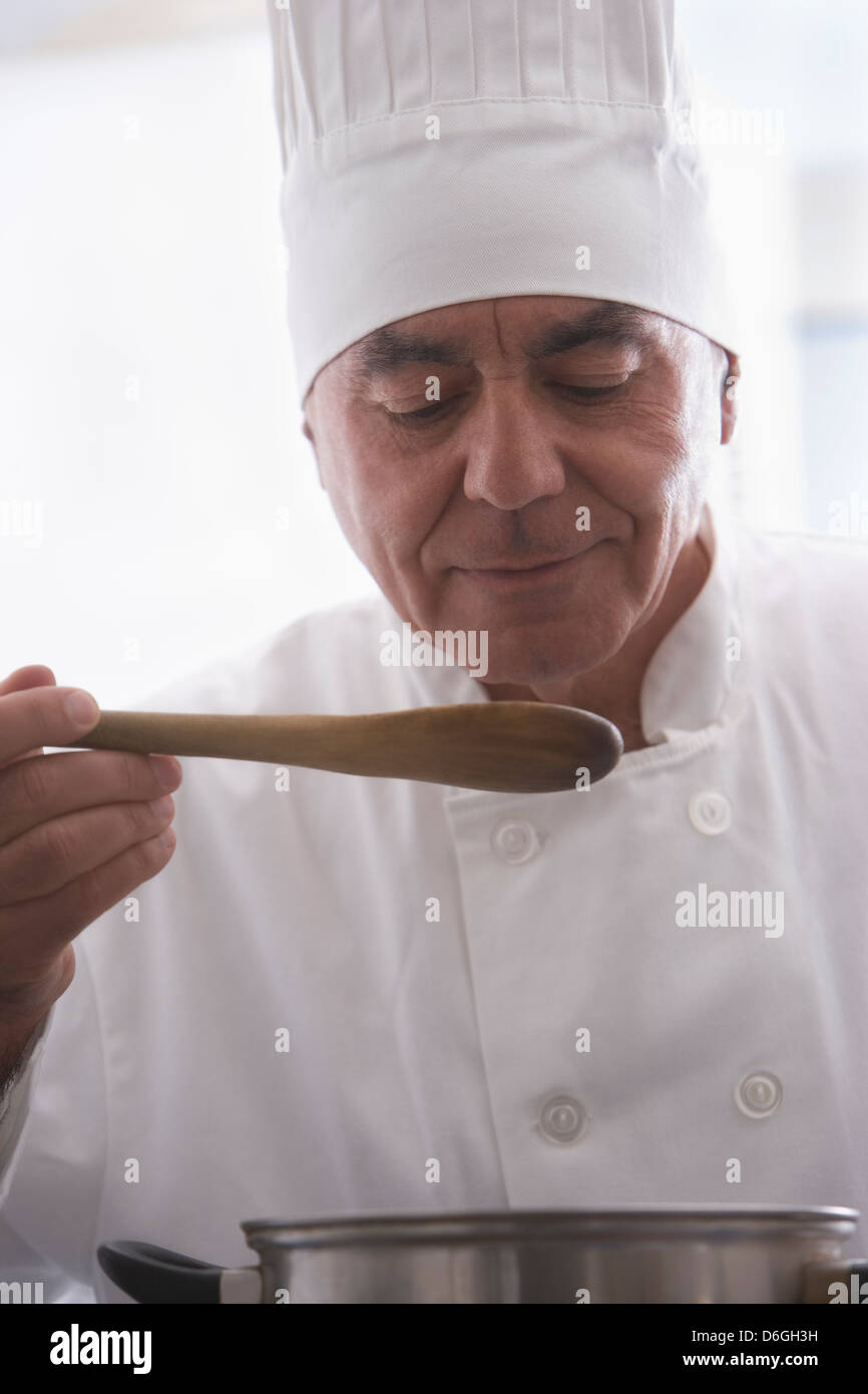 Hispanic chef tasting food in kitchen Stock Photo - Alamy