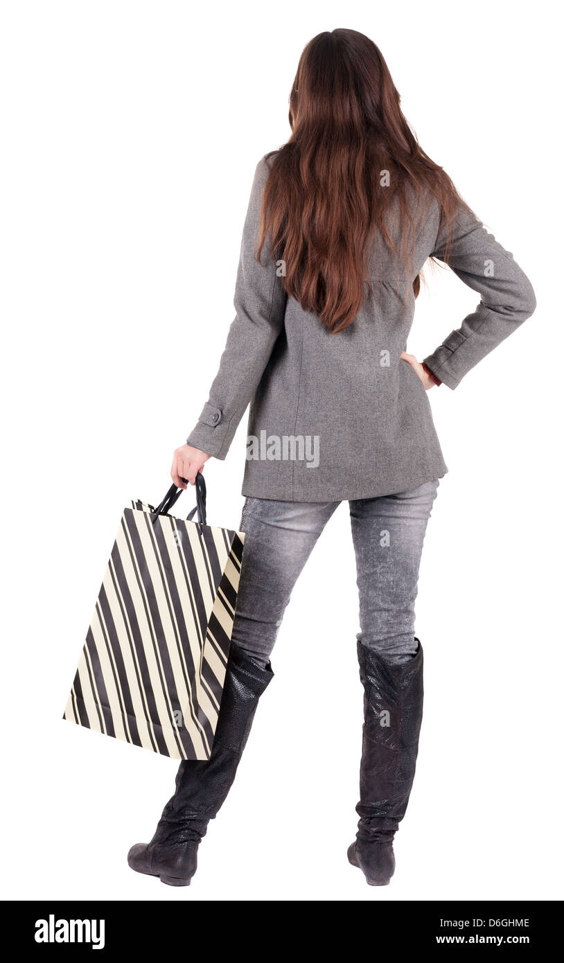 back view of going woman in coat woman with shopping bags . beautiful ...